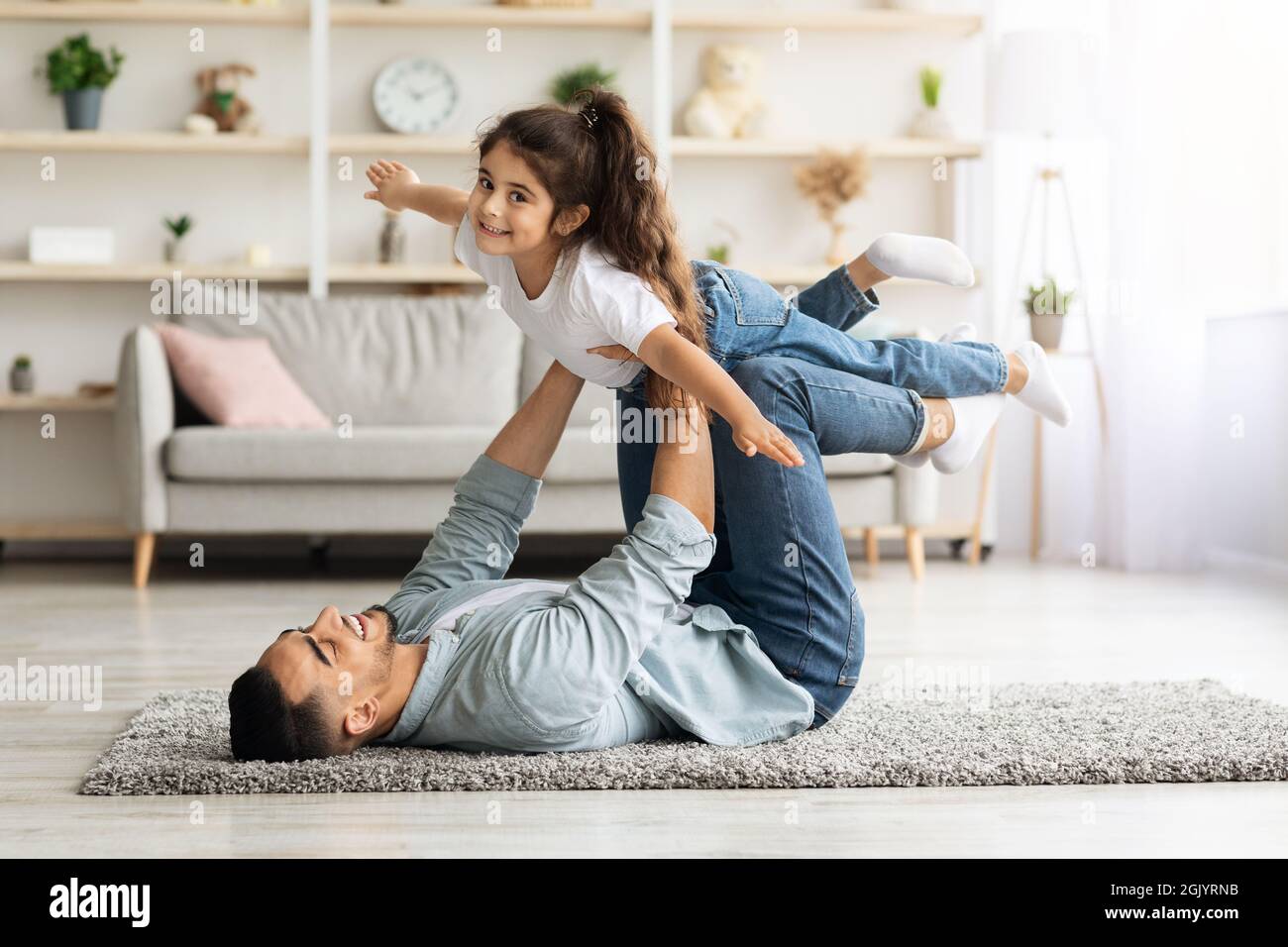 Adorable little girl spending time with her father at home Stock Photo ...