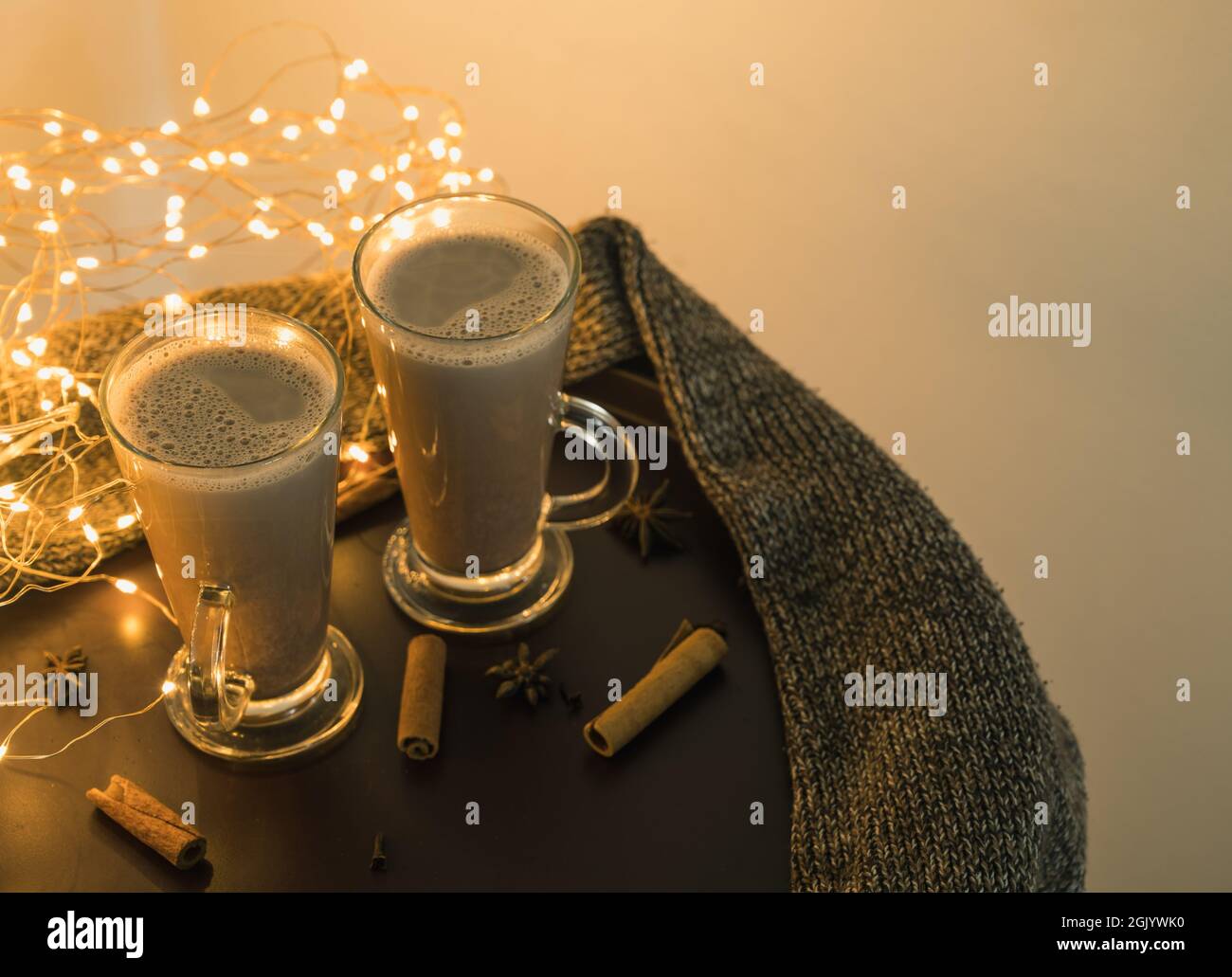 Top view of couple of hot cocoa drinks in glasses on brown table. Hot ...