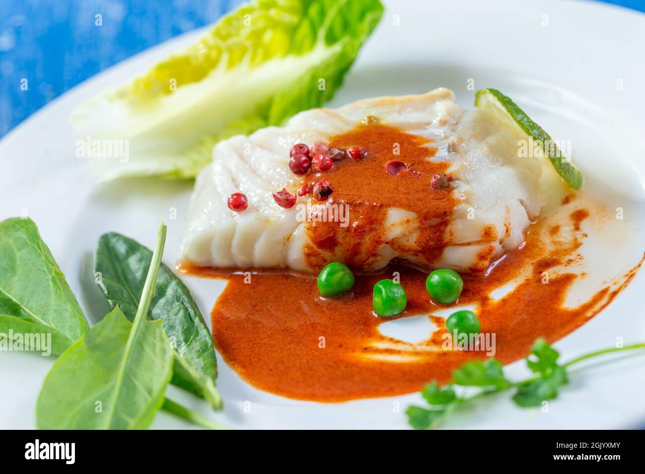 Steamed cod fillet with paprika sauce and salad leaves Stock Photo - Alamy
