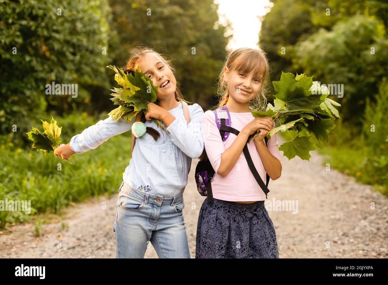 Two girls throwing leaves hi-res stock photography and images - Alamy