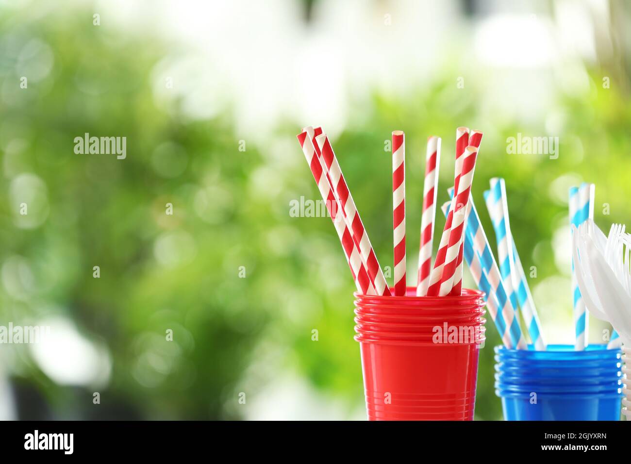 Plastic ware on blurred background outdoors Stock Photo - Alamy