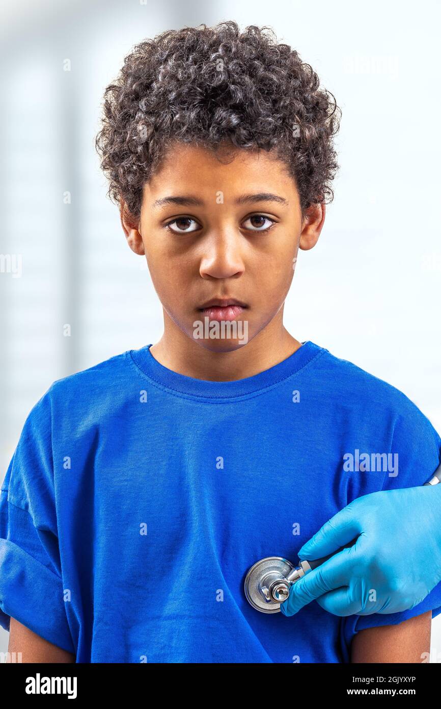 Doctor using a stethoscope to auscultate a pediatric patient's cardiac ...