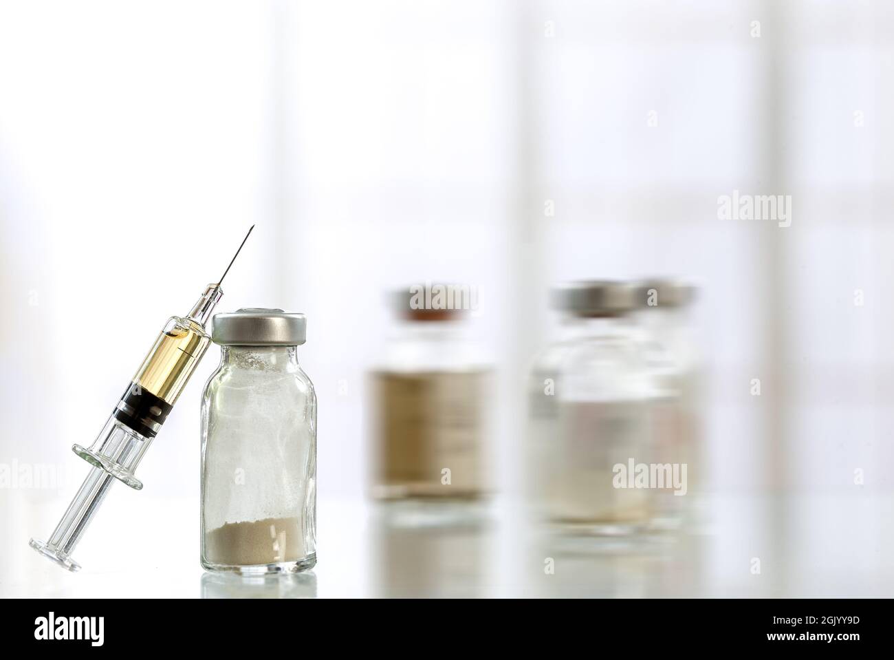 Medicine bottles glass and syringe injection needle on white background ...
