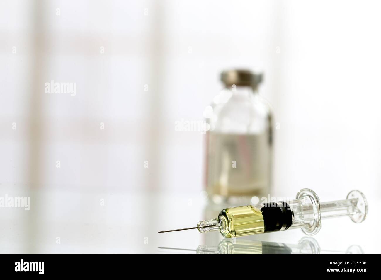 Medicine bottles glass and syringe injection needle on white background ...