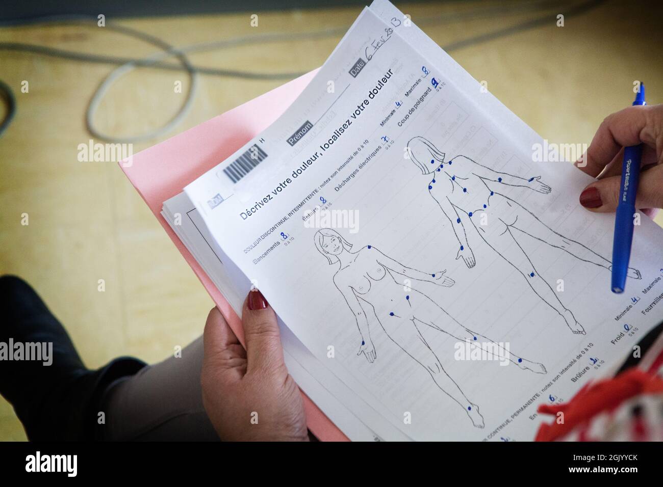 A patient fills out a form to assess and target chronic pain Stock ...