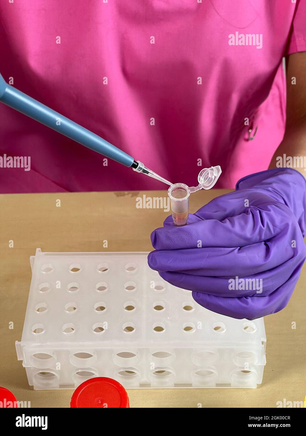 Woman injecting a substance into a tube using a pipette Stock Photo - Alamy