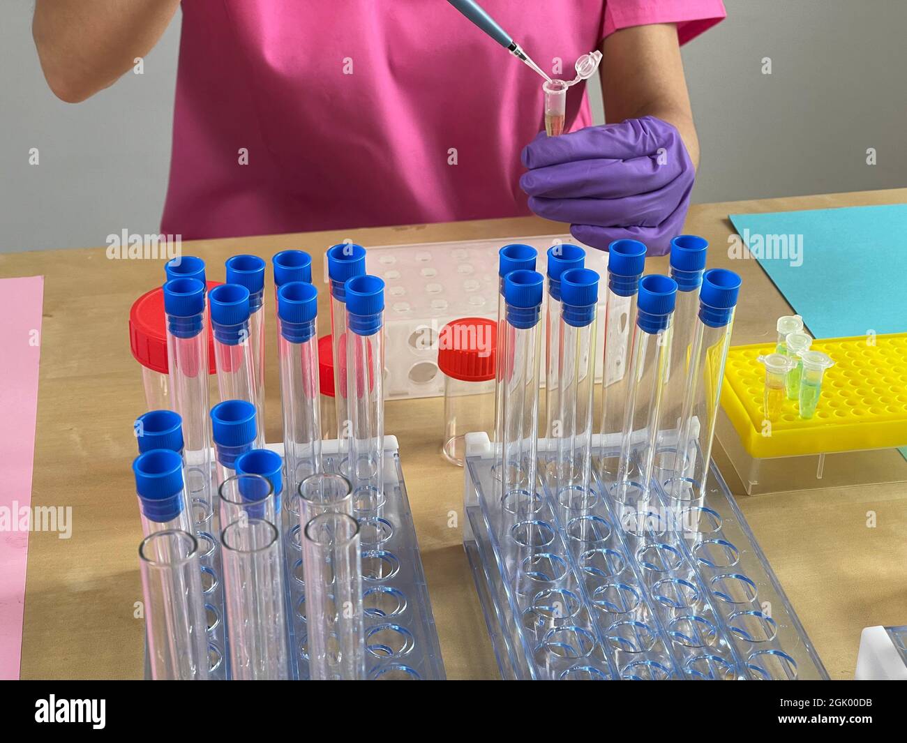 Woman injecting a substance into a tube using a pipette Stock Photo - Alamy