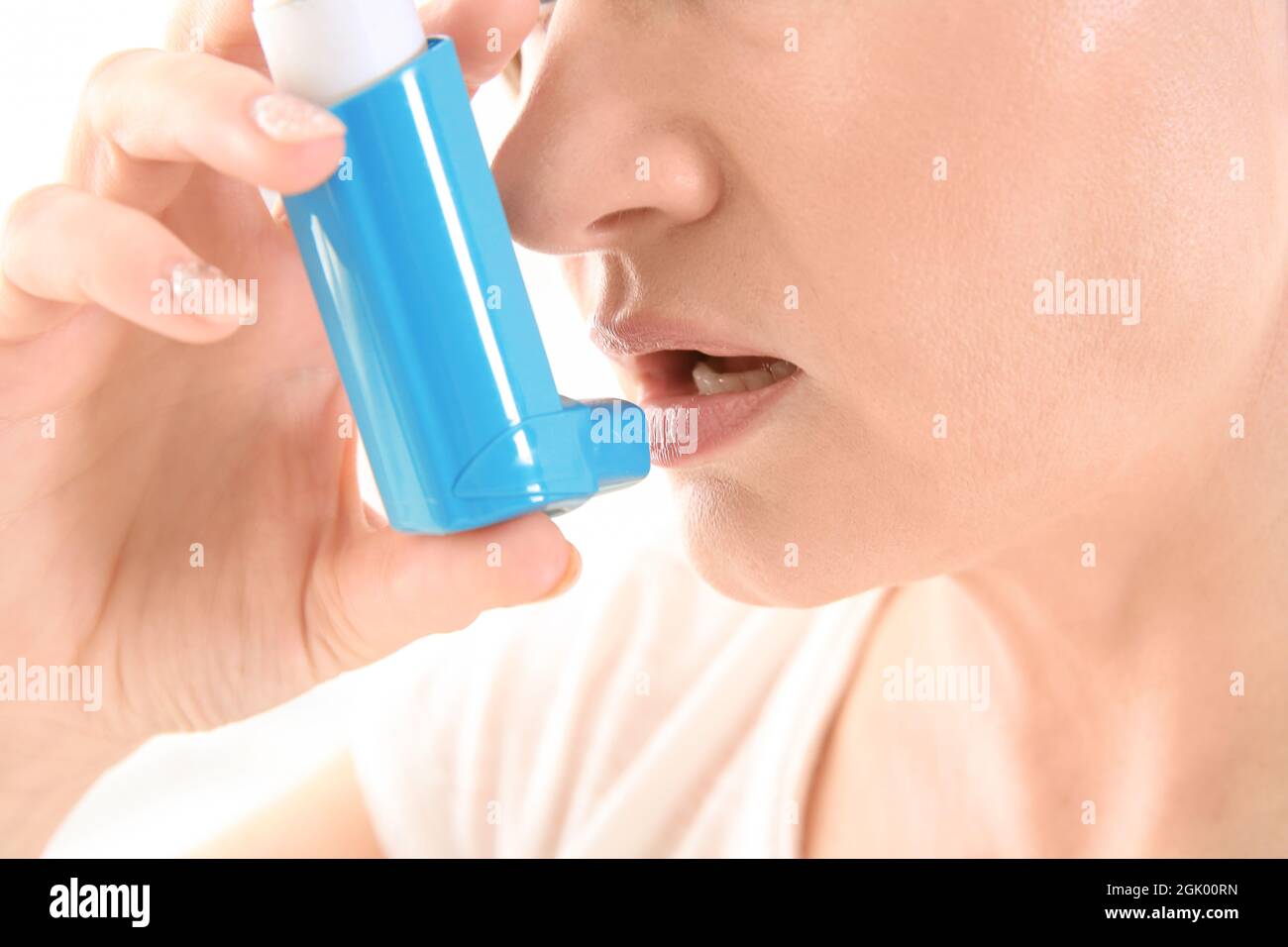 Adult woman using inhaler, closeup Stock Photo - Alamy