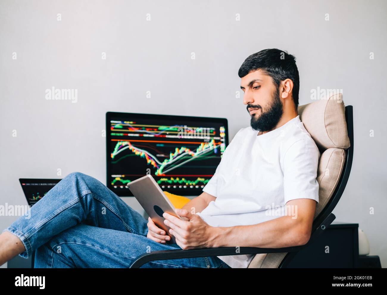 Caucasian businessman trading online, using computer technology ...