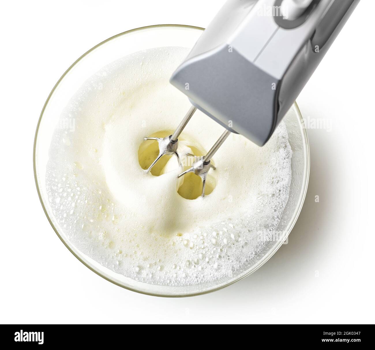 beating egg whites cream with mixer in the bowl isolated on white ...