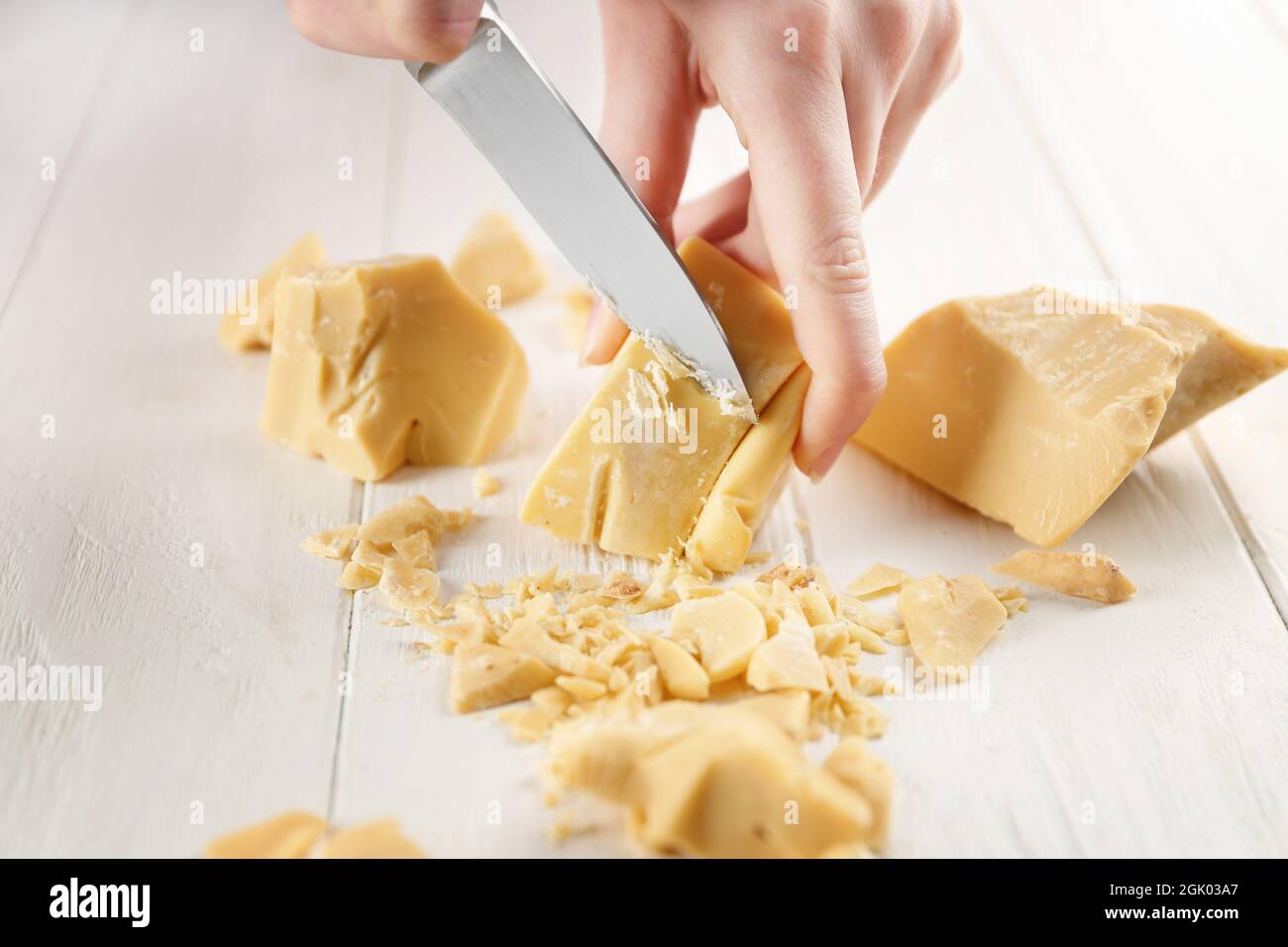 Female hands cutting cocoa butter, closeup Stock Photo - Alamy