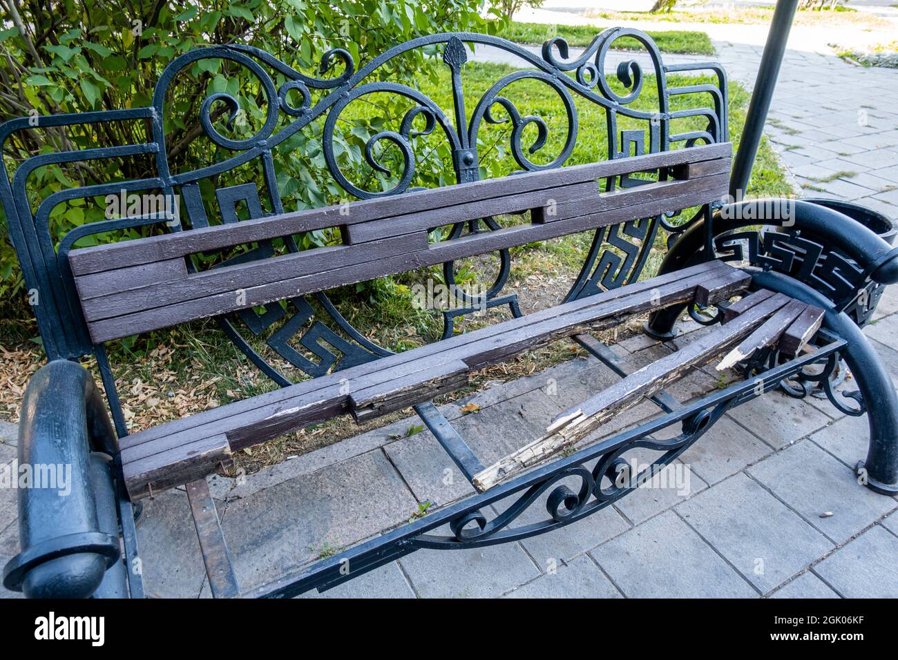 Street bench with broken wooden frame Stock Photo - Alamy