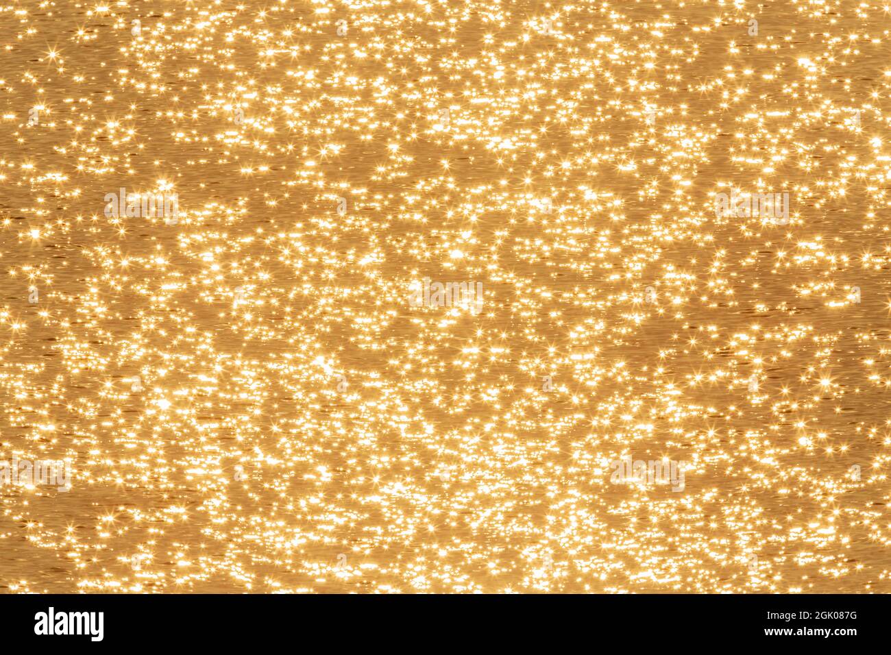 shining backdrop: golden abstract sunshine on water background Stock ...