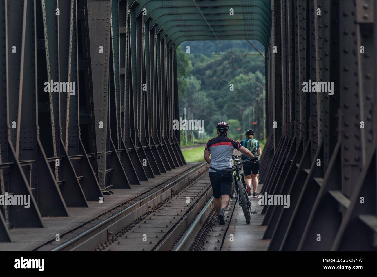 Dangerous path over railway bridge with sport bicycle Stock Photo - Alamy