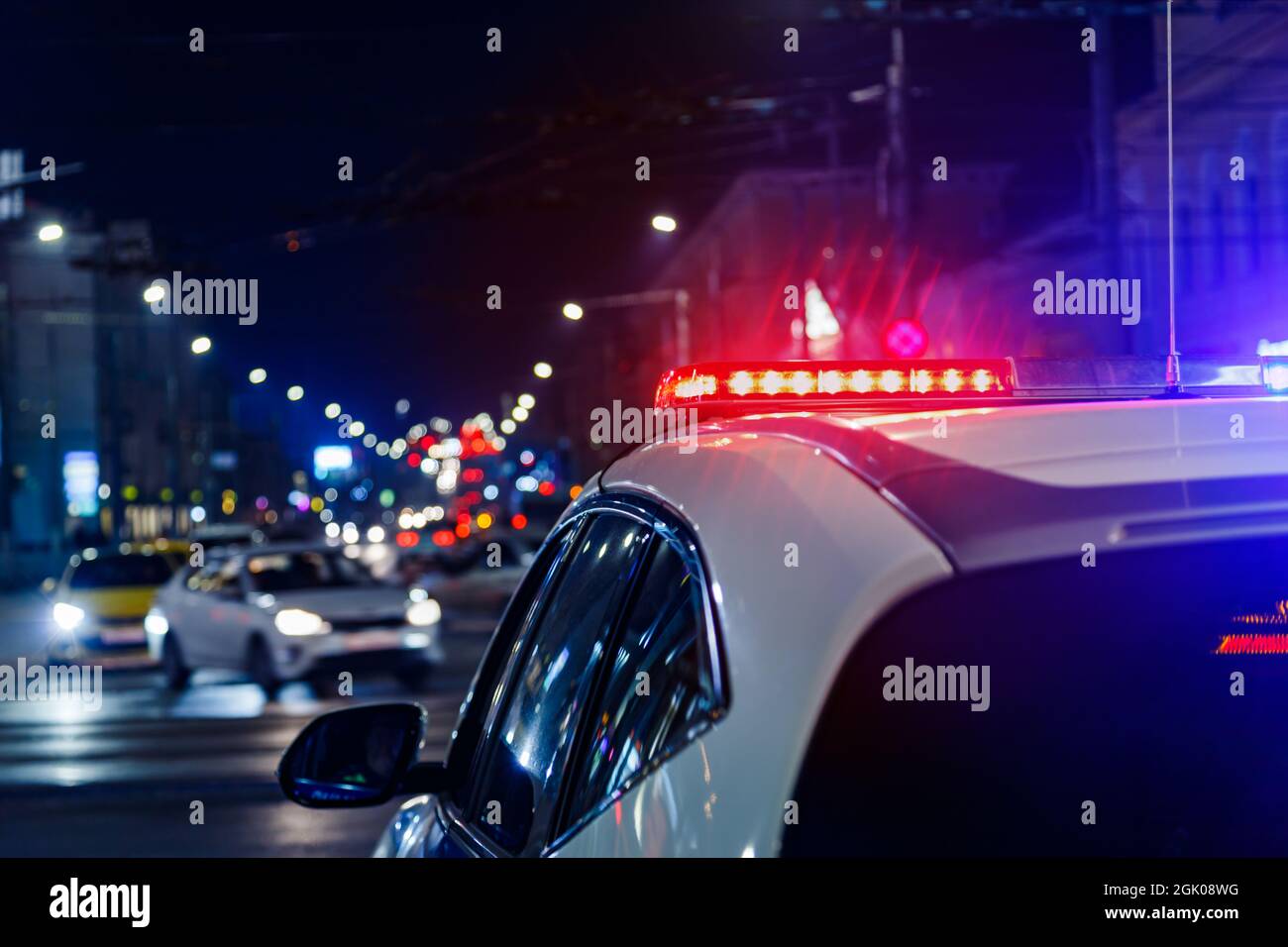 police car lights at night in city with selective focus and blurry car ...