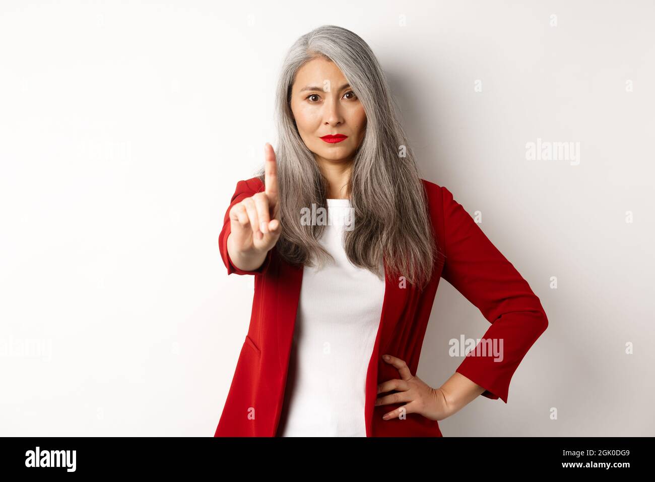 Serious and disappointed asian businesswoman showing stop gesture ...