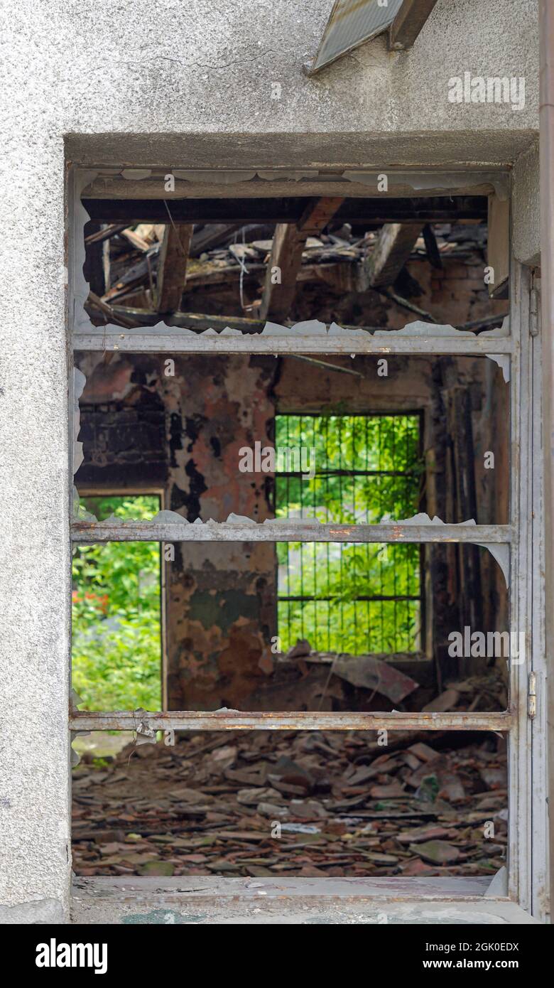 All glass broken at window frame house damage Stock Photo - Alamy