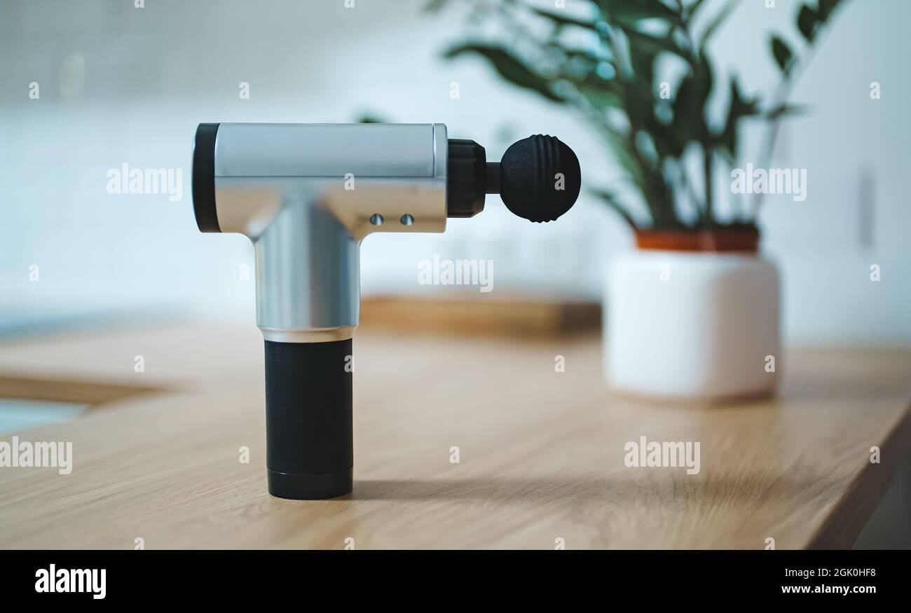 Massage percussion device on the table Stock Photo - Alamy