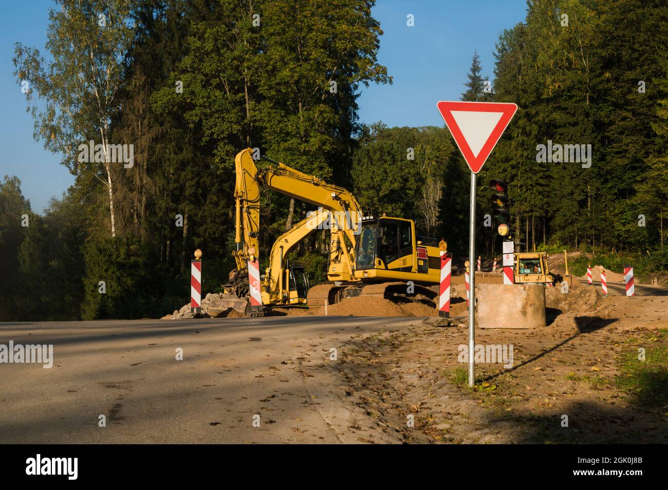 The process of building a new road. Yellow excavators. Heavy equipment ...