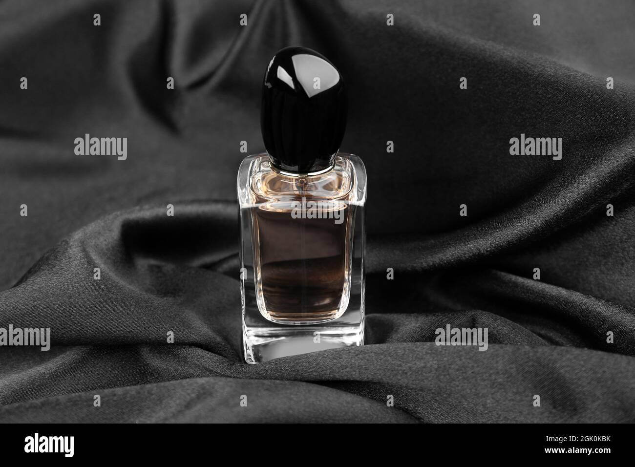 Perfume bottle on cloth Stock Photo - Alamy