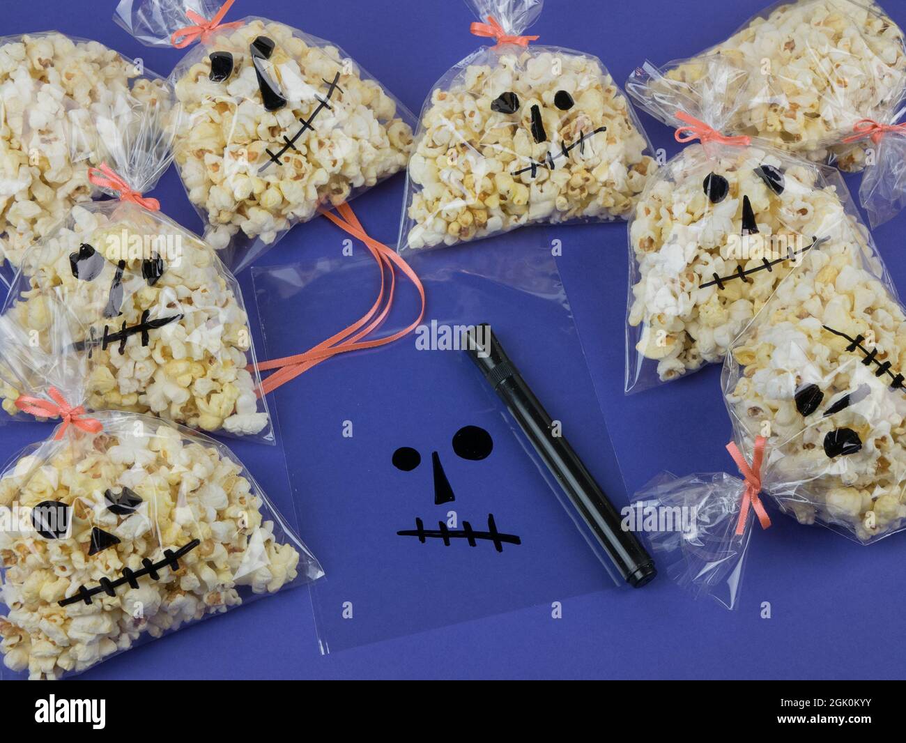 Preparing Halloween gifts. Woman's hands creating Halloween packaging ...