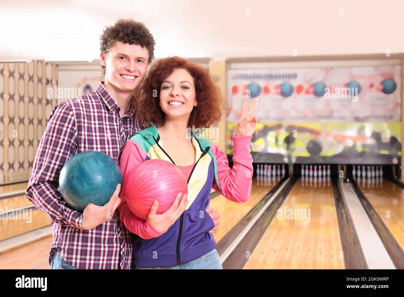 Happy couple playing bowling together Stock Photo - Alamy
