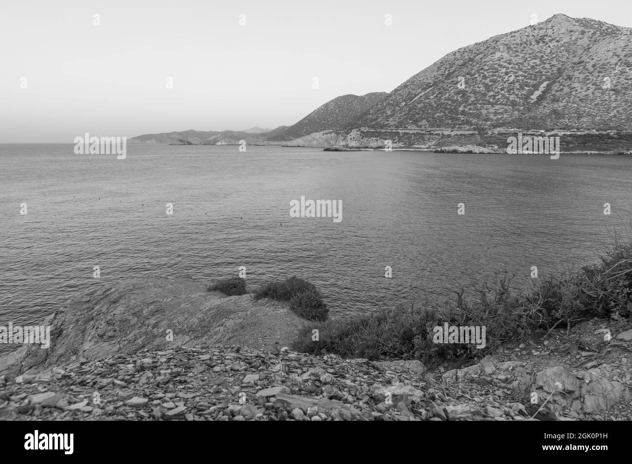 A grayscale of blue water and mountains under blue sunny sky in Bali ...