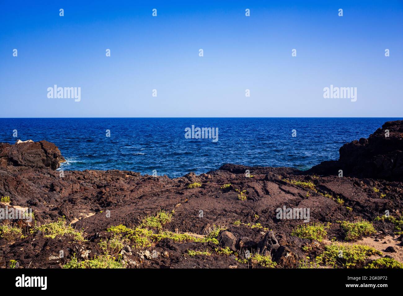 View of the scenic lava rock cliff in the Linosa island. Sicily Stock ...