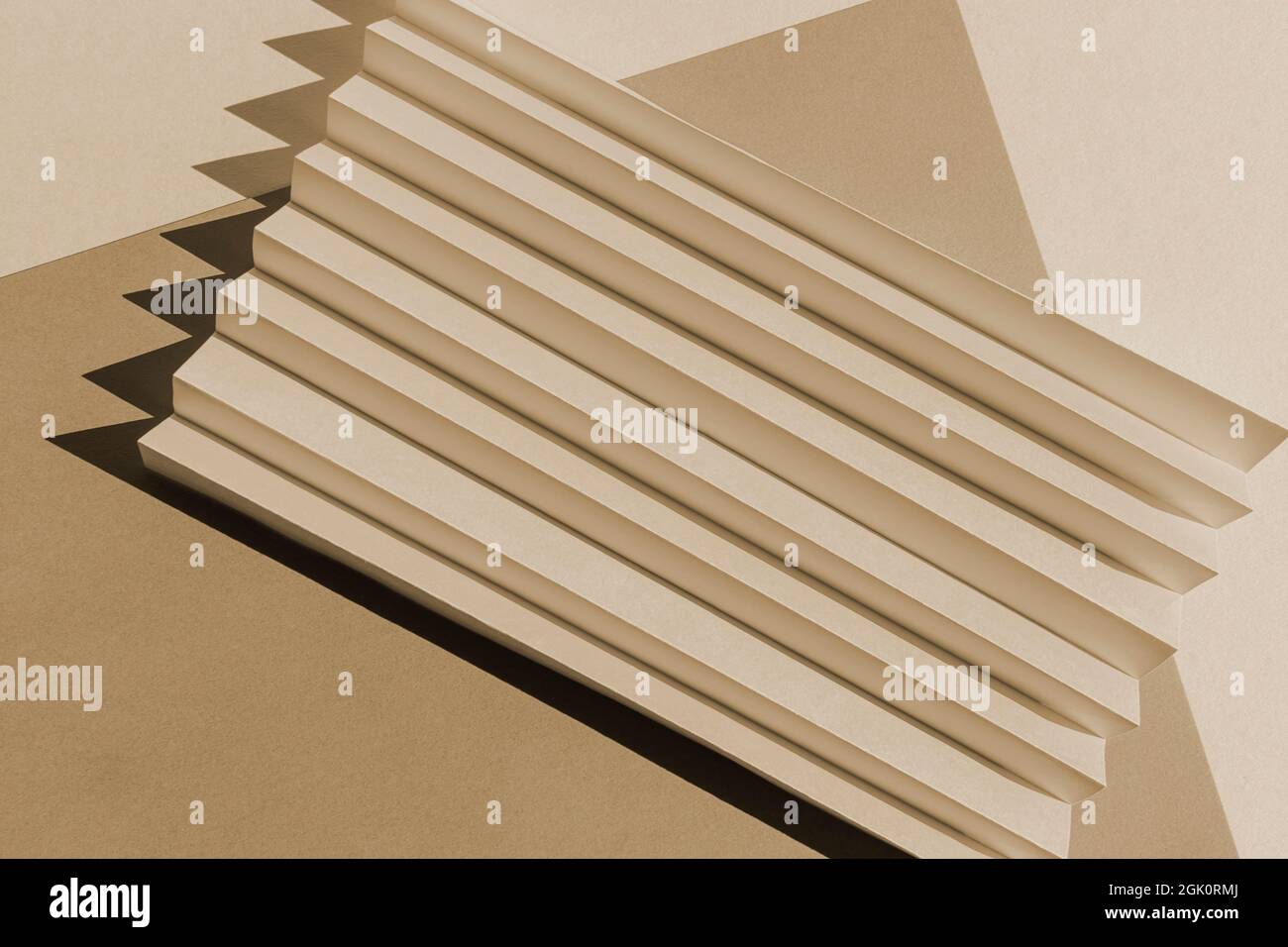 Abstract beige colored paper texture. Folded paper with harsh sun ...
