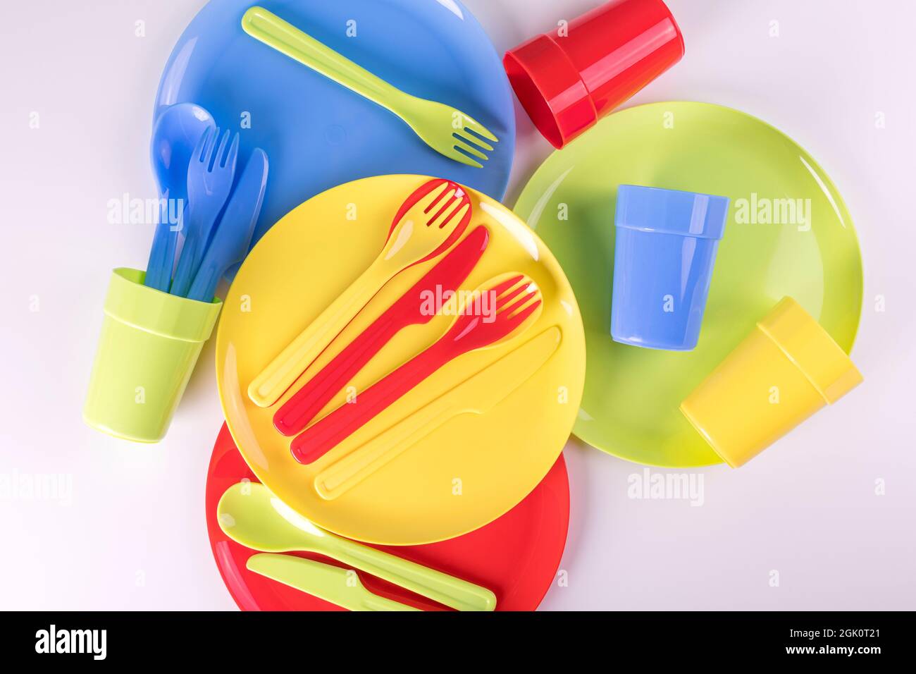 Bright colorful plastic disposable tableware isolated on white ...