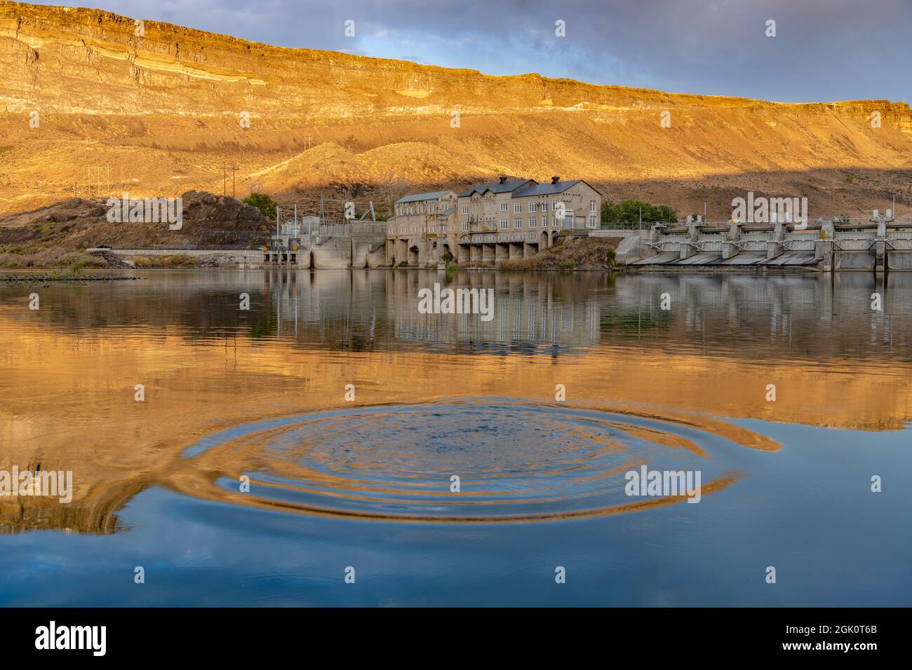 Sunset warm colors light the canyon walls over hydroelectric Dam Stock ...