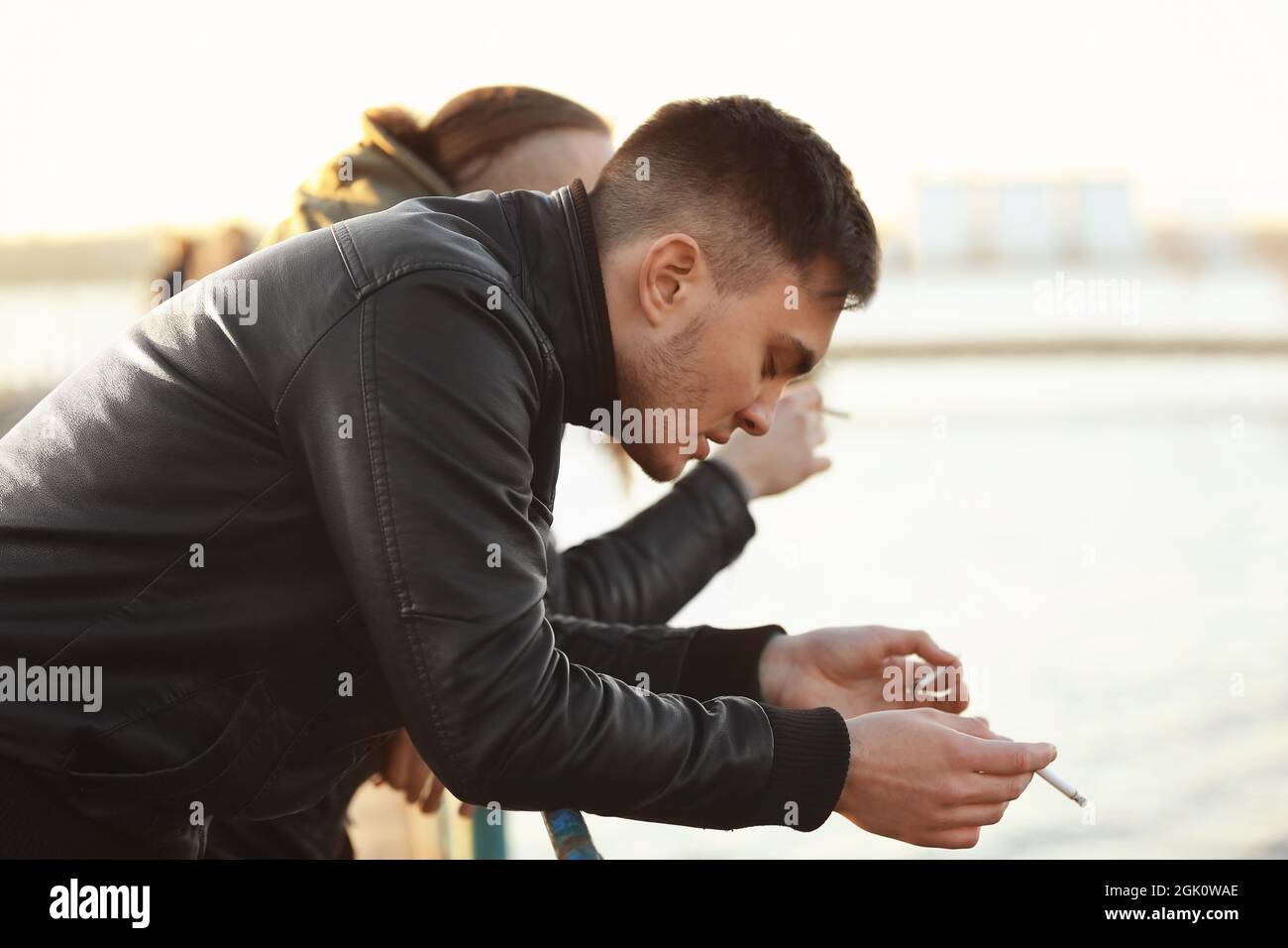 Young man smoking weed outdoors Stock Photo - Alamy