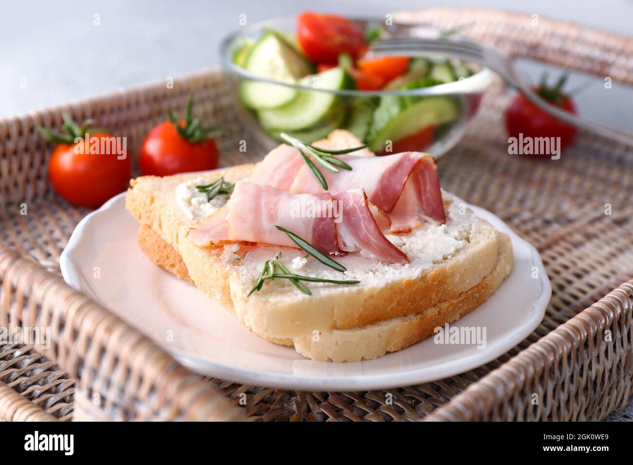 Tasty sandwich and salad for breakfast on wicker tray Stock Photo - Alamy