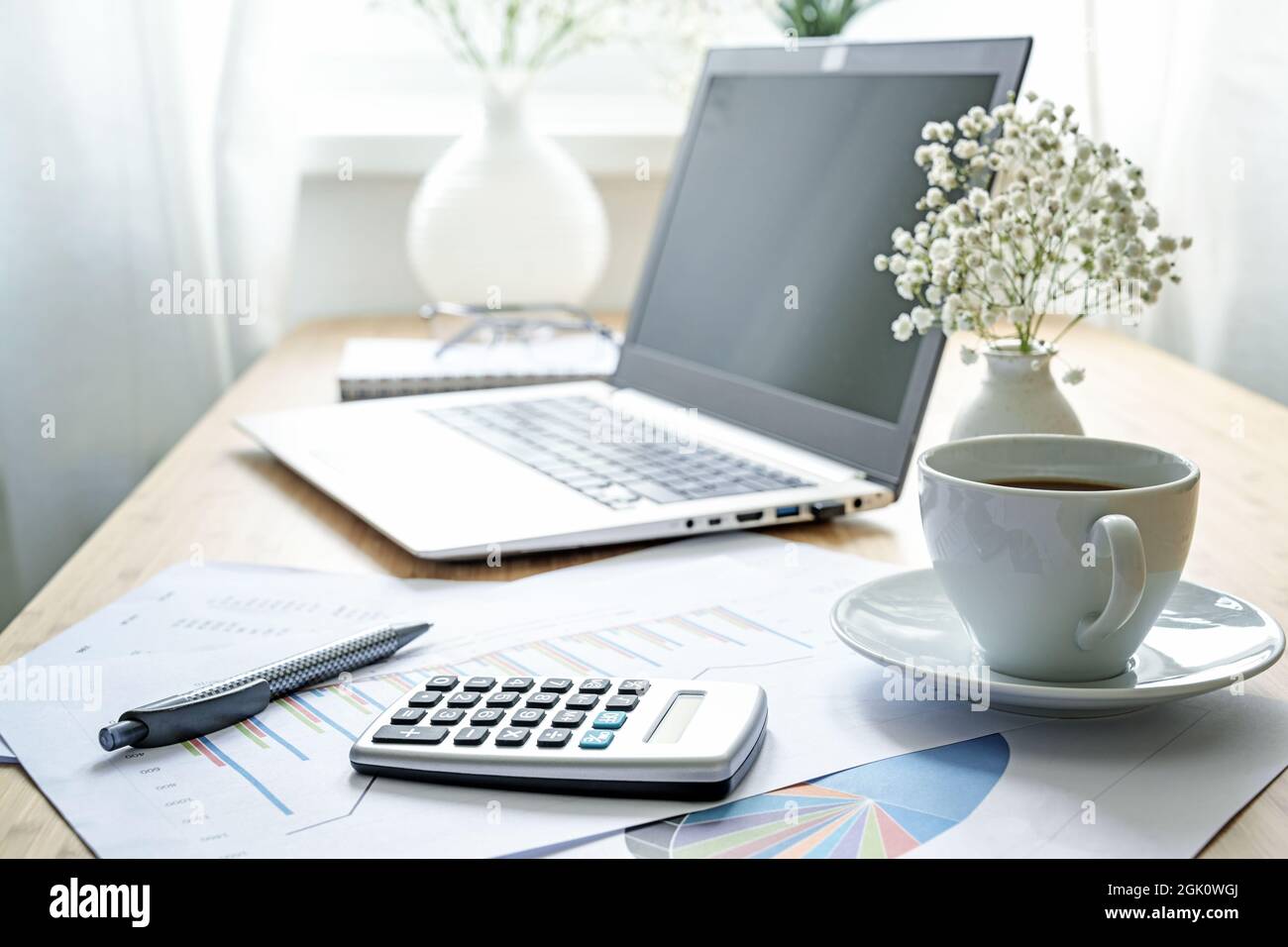 Office desk with laptop computer, calculator, accounting documents ...