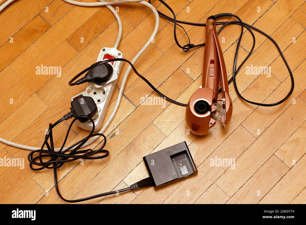 Electrical extension cable charging several devices with adapters on ...