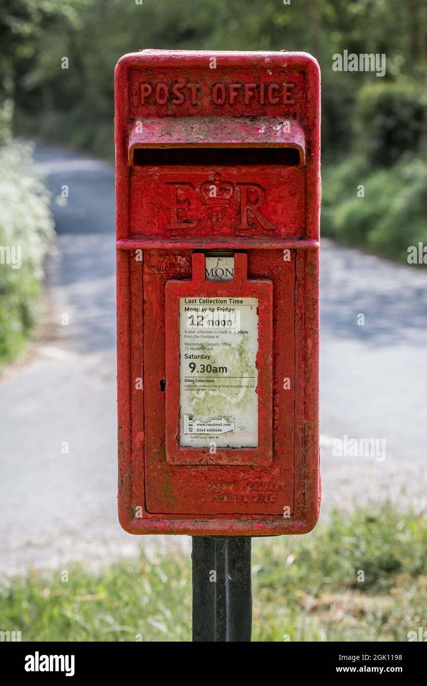 Red rectangular post office box on post in village road in Chapmanslade ...
