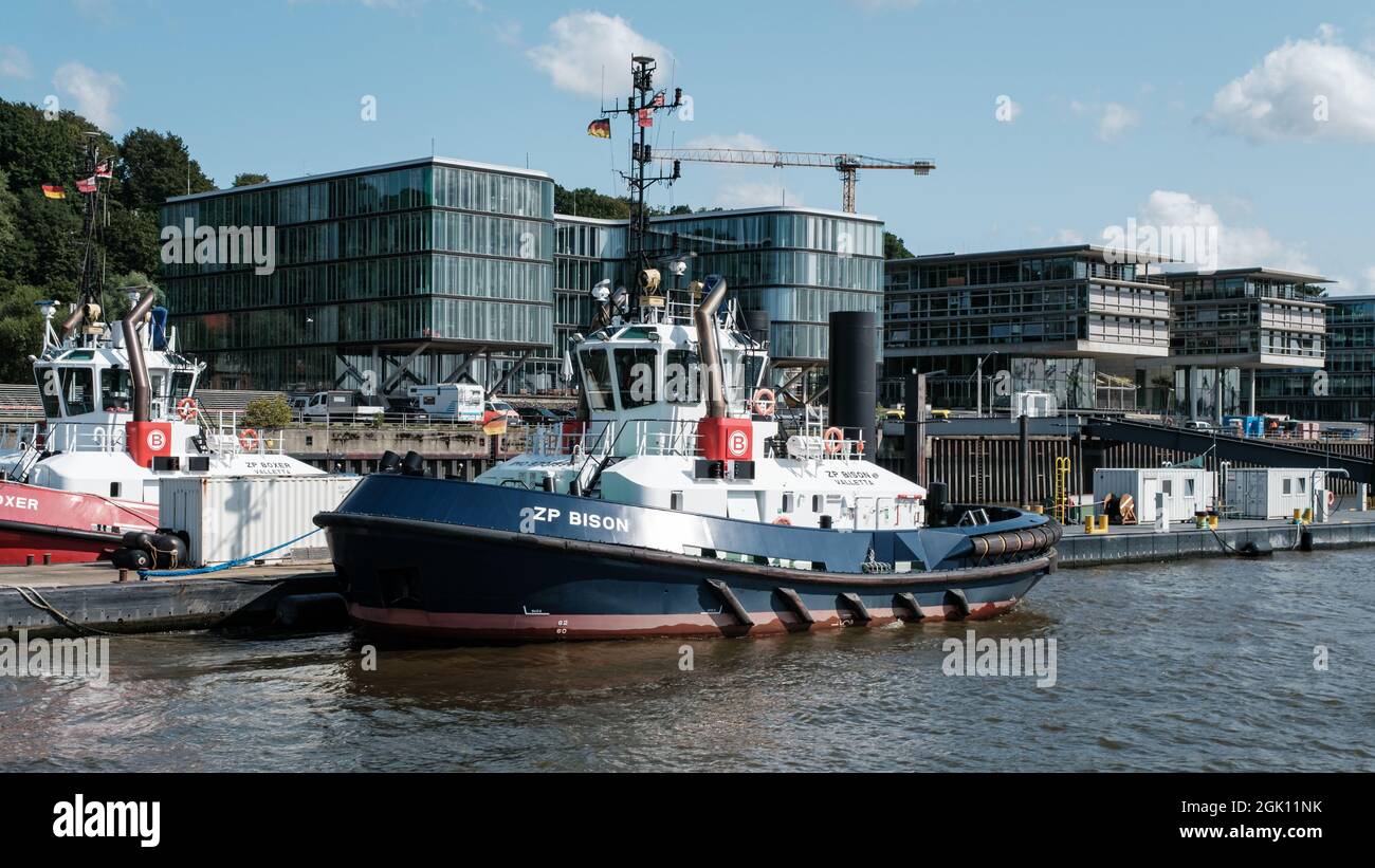 HAMBURG, GERMANY - Aug 23, 2021: A tugboat on the water surrounded by ...
