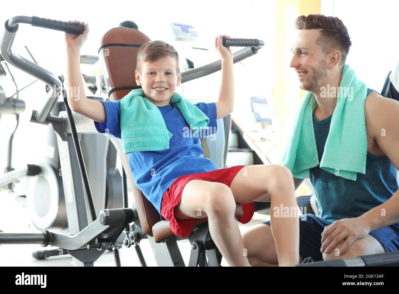 Dad and son training in gym Stock Photo - Alamy
