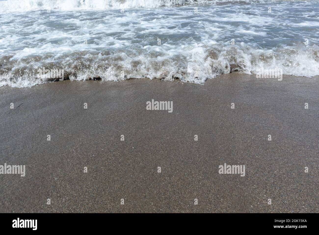 The waves ending at a sand beach Stock Photo - Alamy
