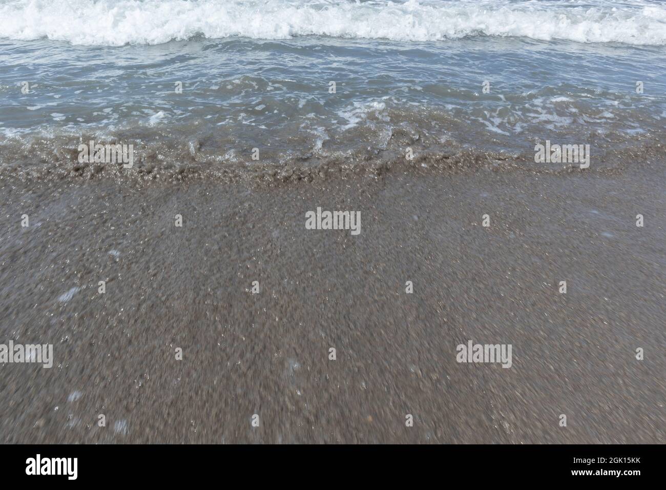 The waves ending at a sand beach Stock Photo - Alamy