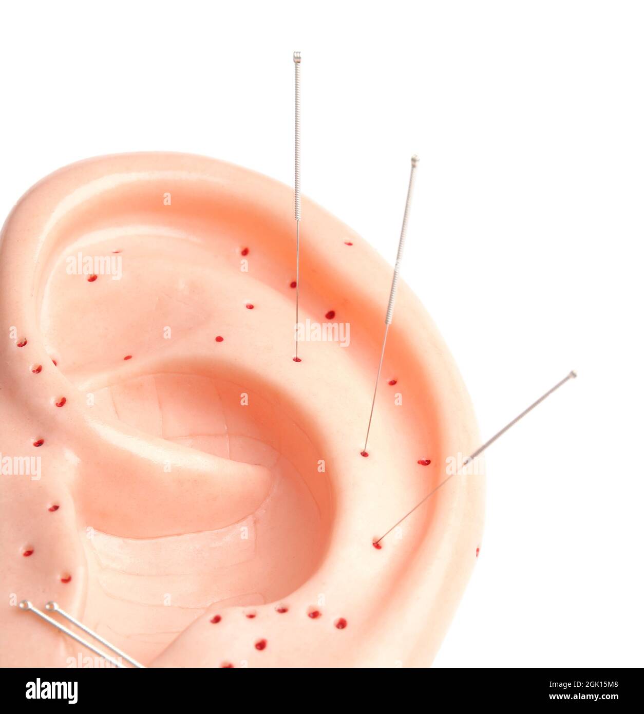 Needles for acupuncture and plastic mockup of human ear on white ...