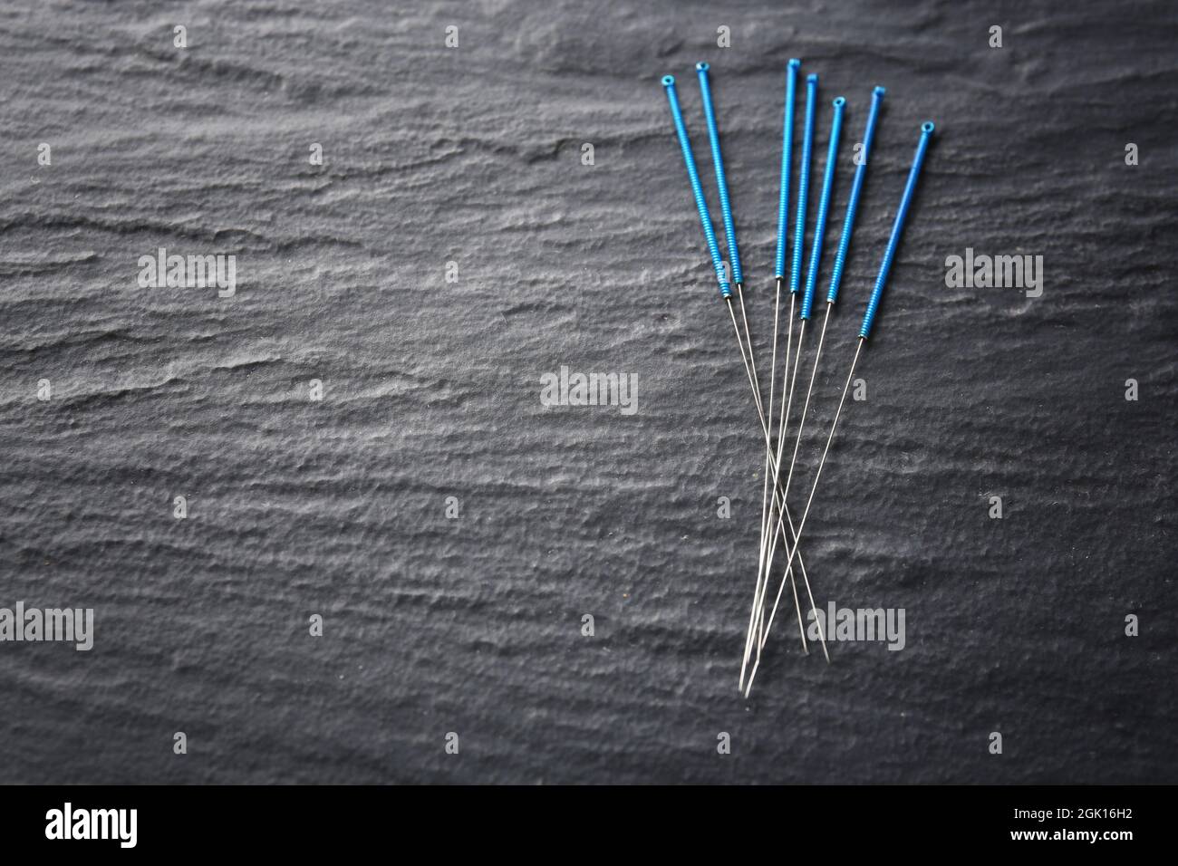 Needles for acupuncture on dark textured background Stock Photo - Alamy