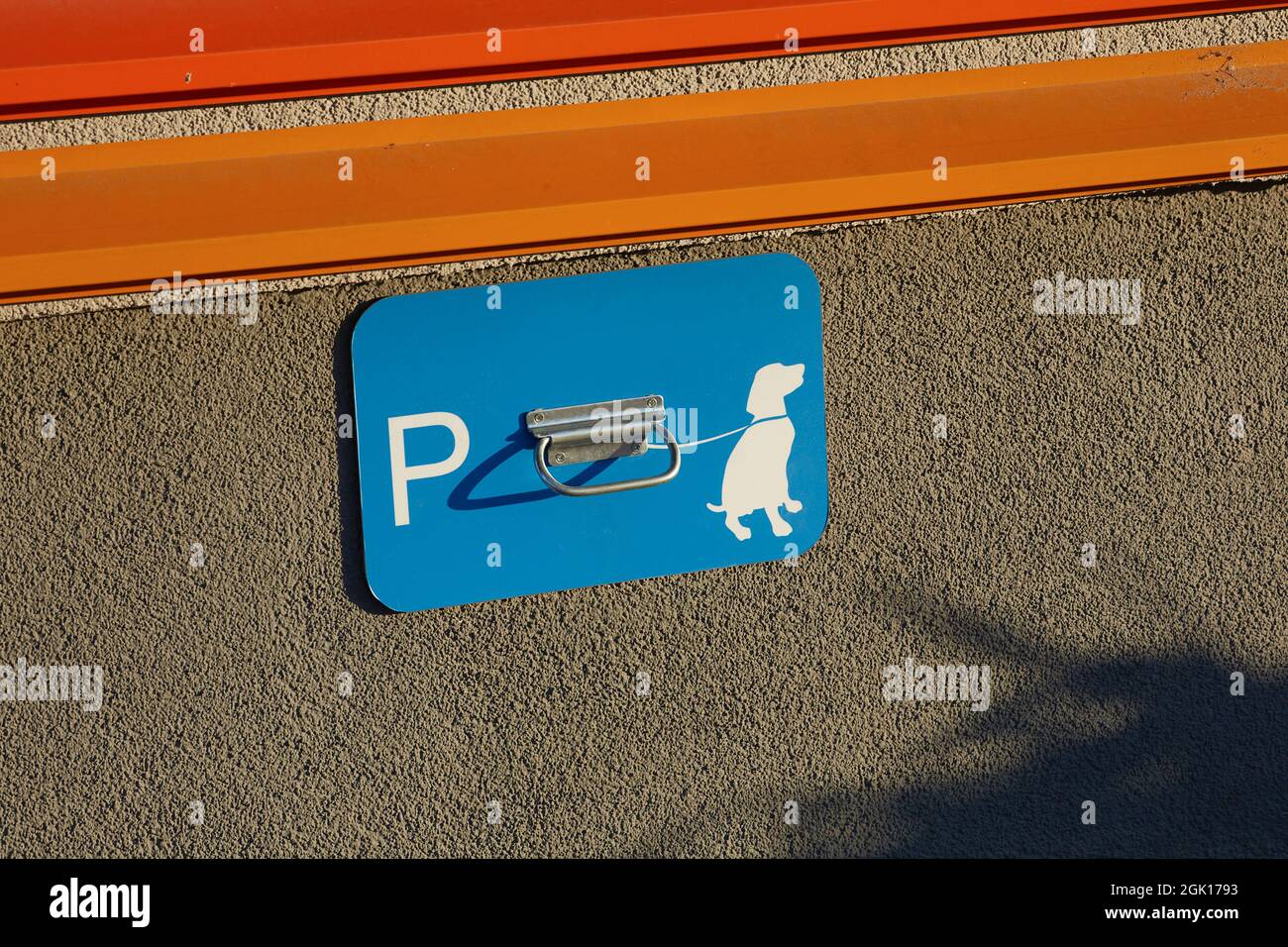 Dog parking sign on the wall of supermarket. Place for bind dogs ...