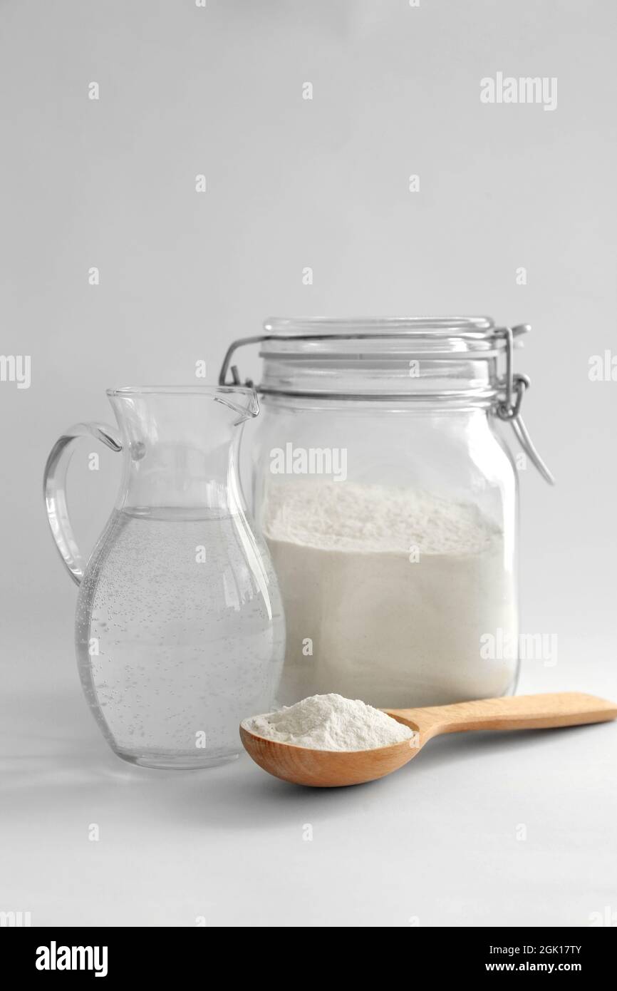 Flour and water on white background Stock Photo - Alamy