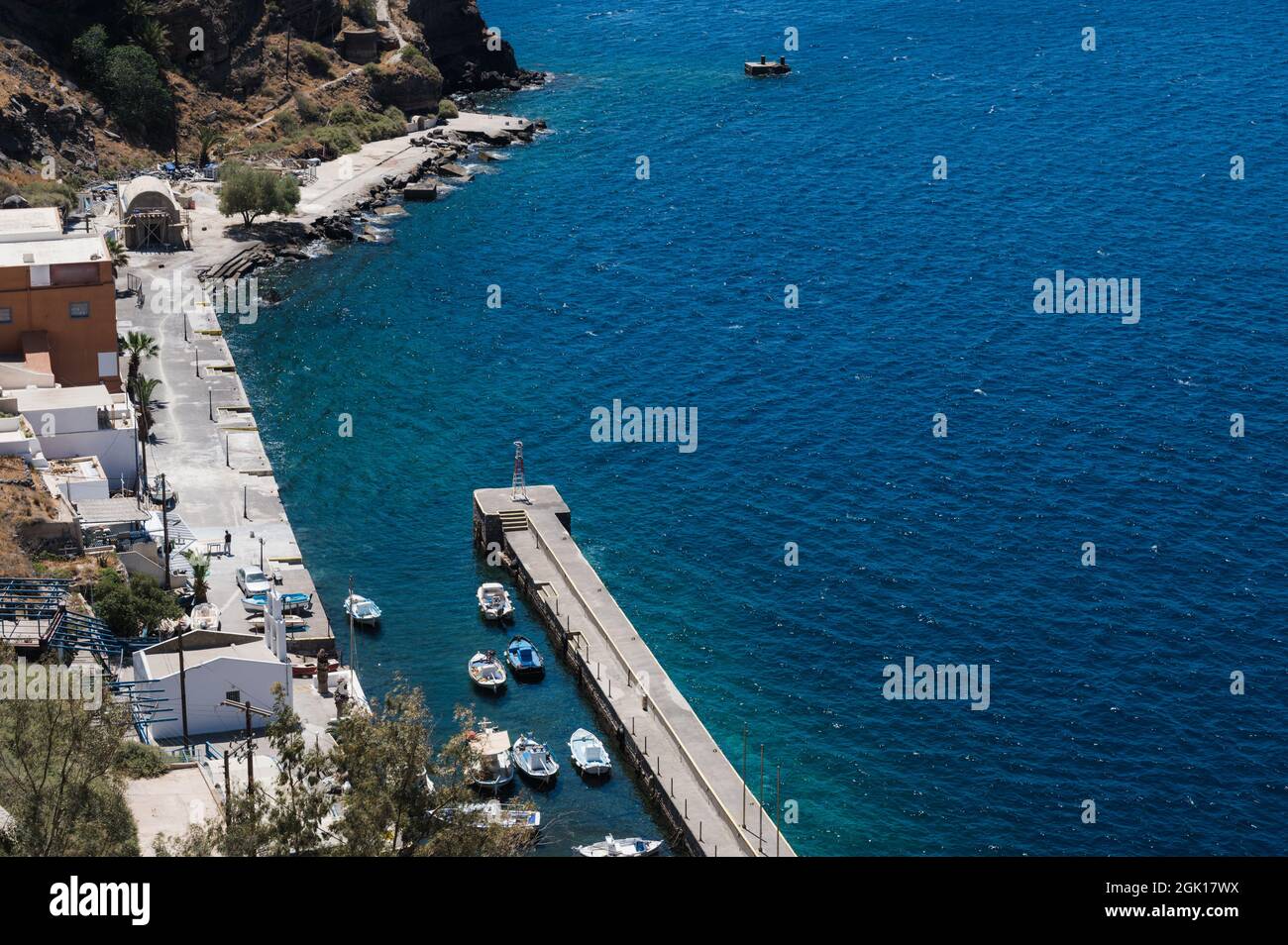 Top view of blue Aegean sea and old port of Thira on Santorini island ...