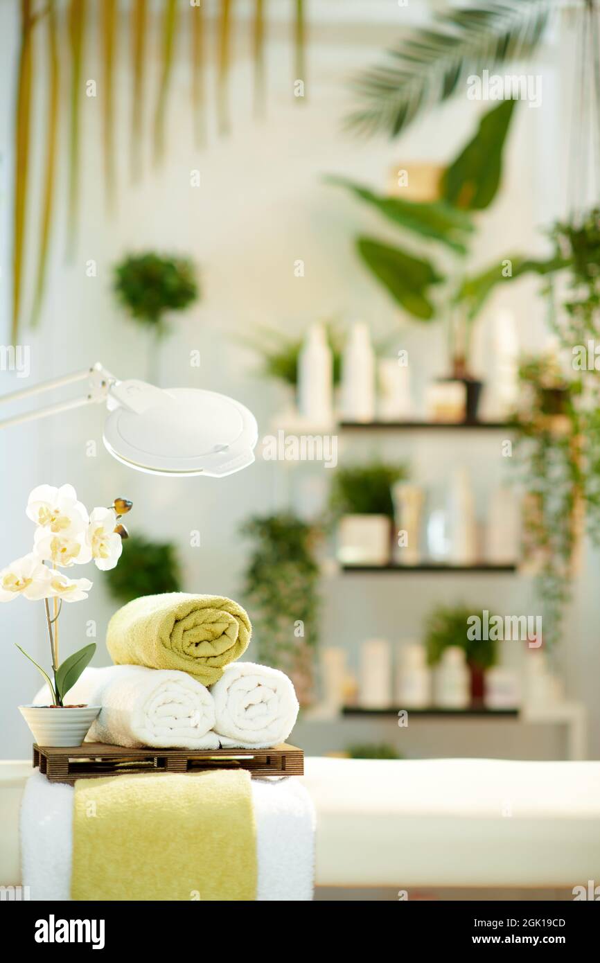 towels and massage table in modern beauty salon Stock Photo - Alamy