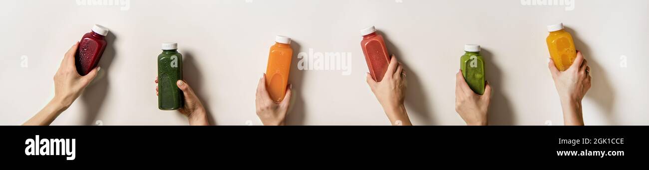 Human hands holding fresh juices in bottles, wide composition Stock ...
