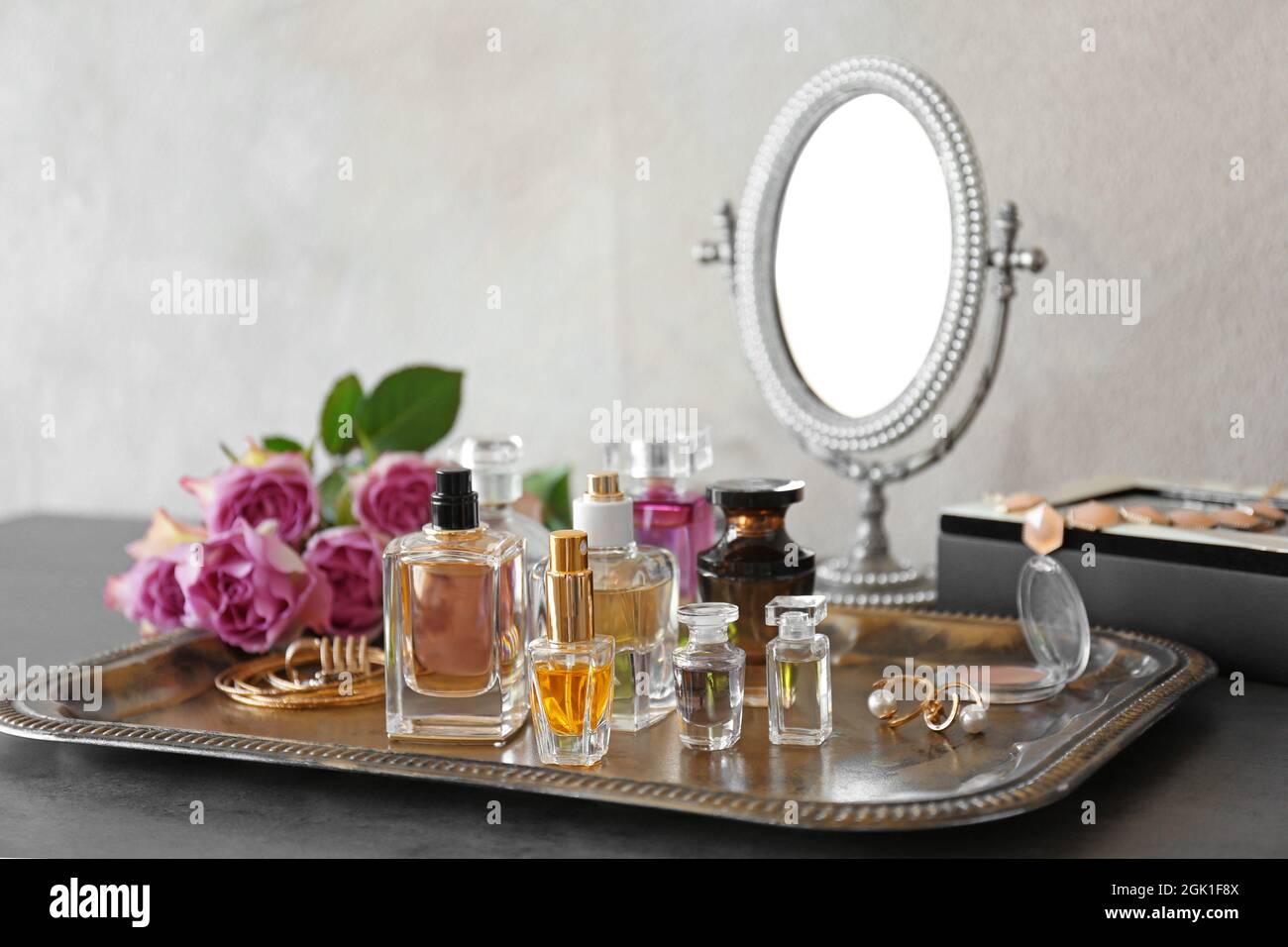 Metal tray with bottles of perfume on table Stock Photo - Alamy