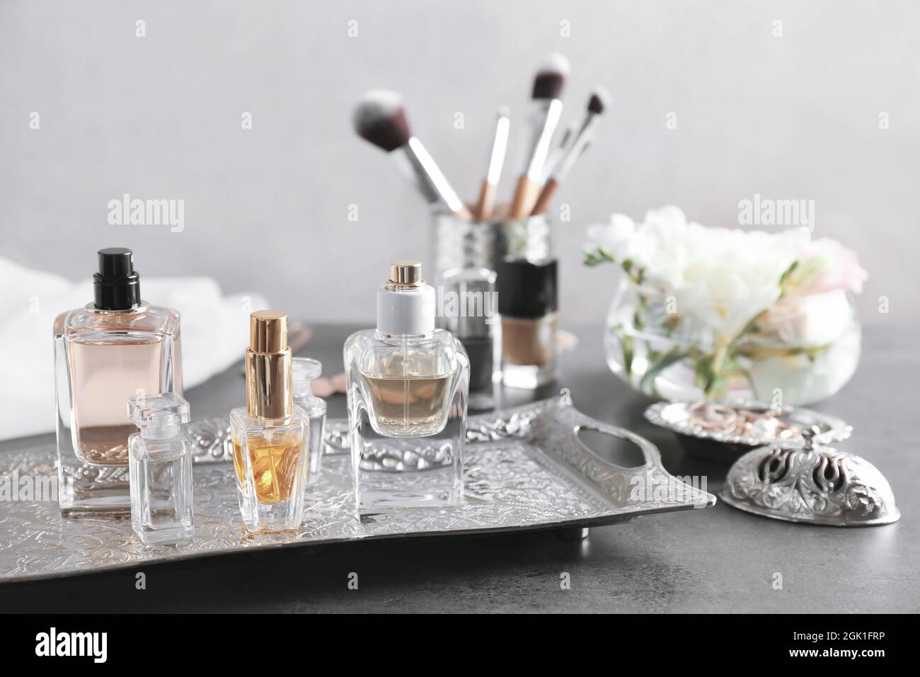 Metal tray with bottles of perfume on table Stock Photo - Alamy