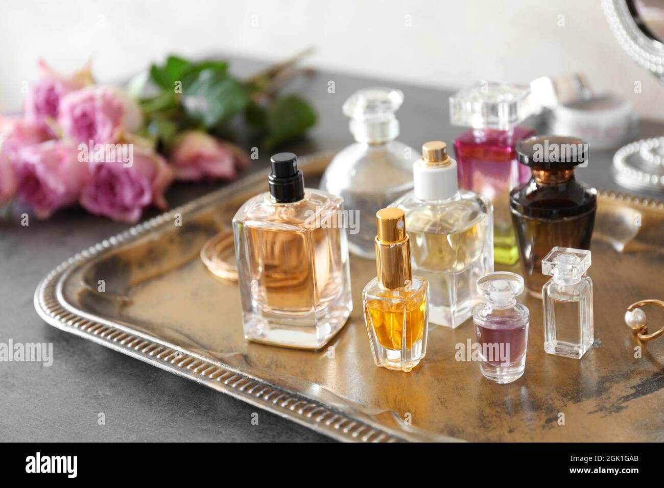 Metal tray with bottles of perfume on table Stock Photo - Alamy